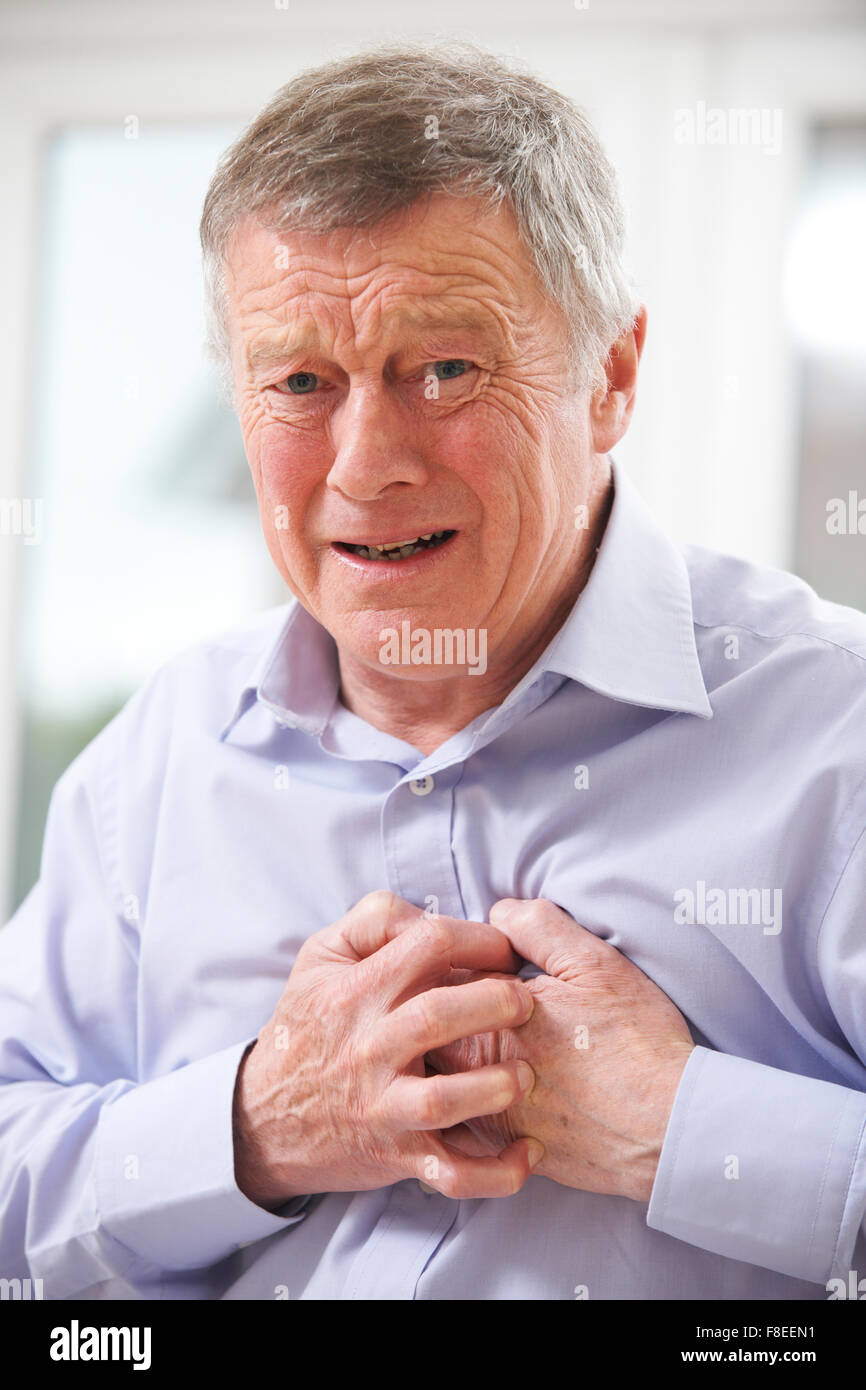 Senior Man Suffering Heart Attack At Home Stock Photo - Alamy