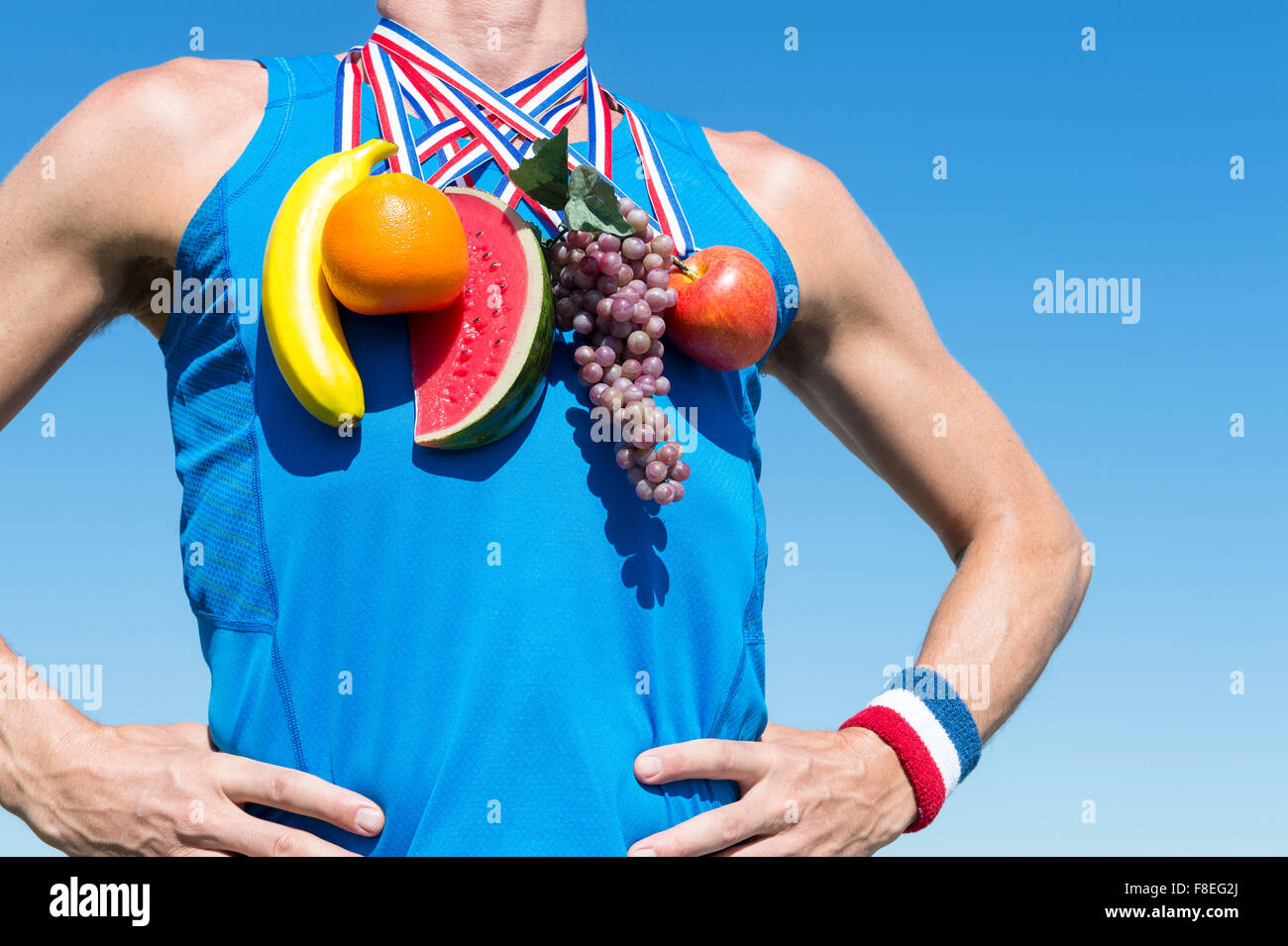 Winner of healthy eating competition standing at blue sky with fruit ...