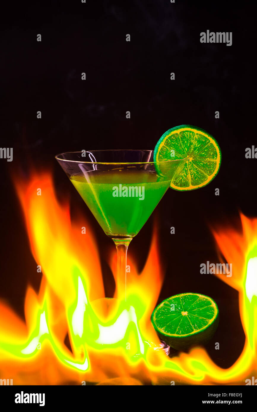 colorful cocktail in nice green color to front of a black background ...