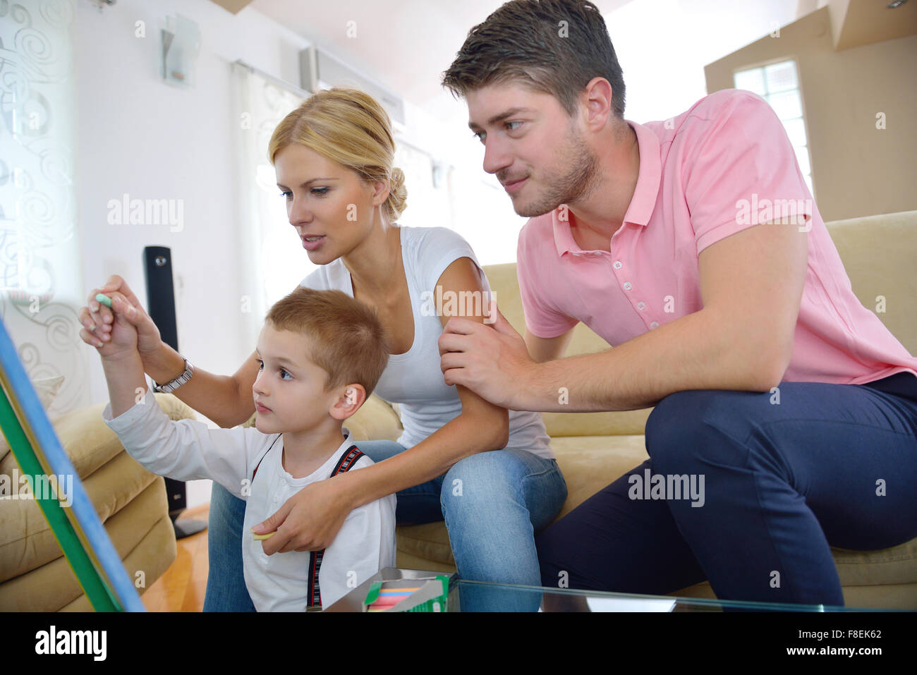 happy young family teach leassons and prepare their son for school ...