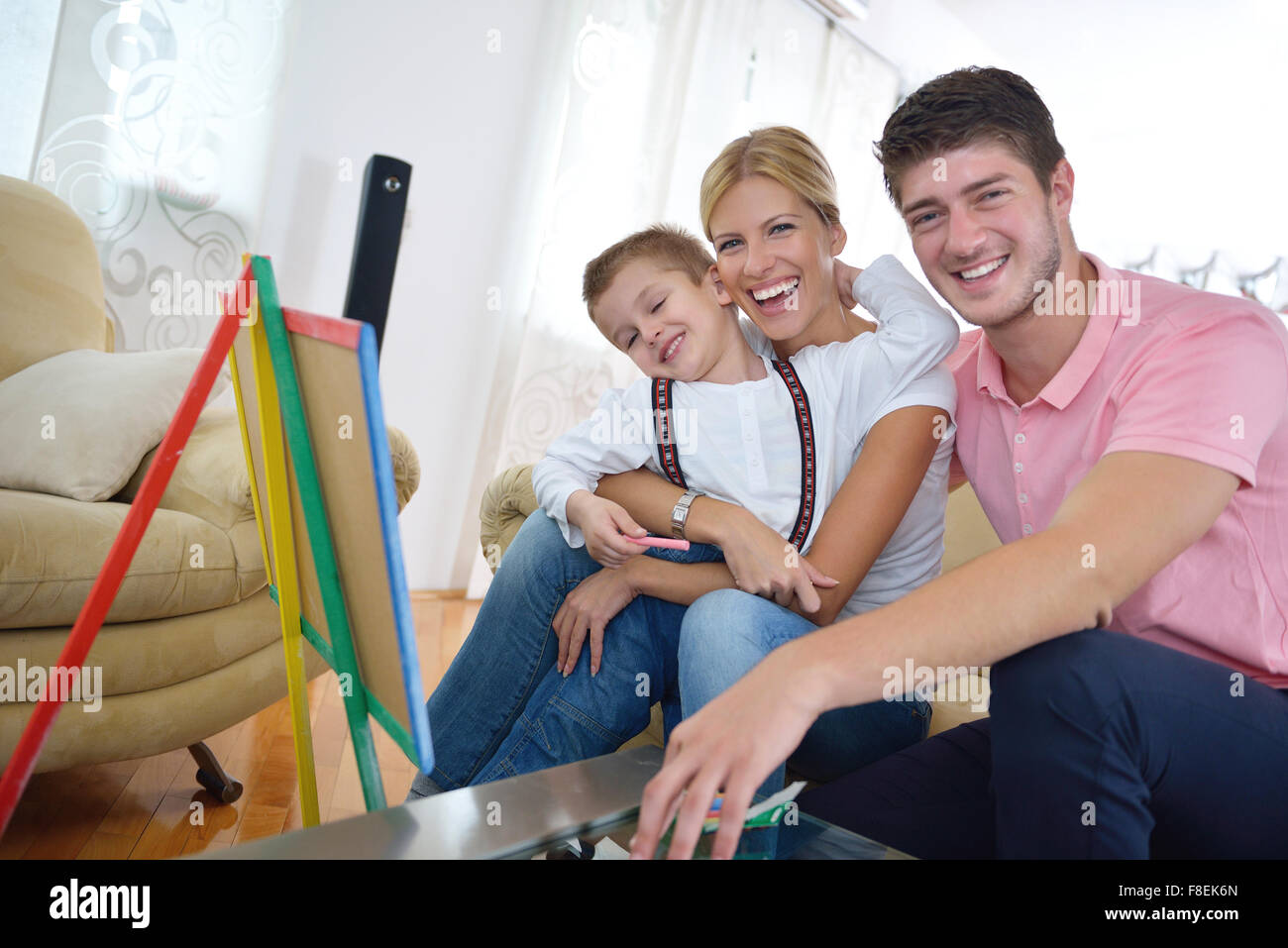 happy young family teach leassons and prepare their son for school ...
