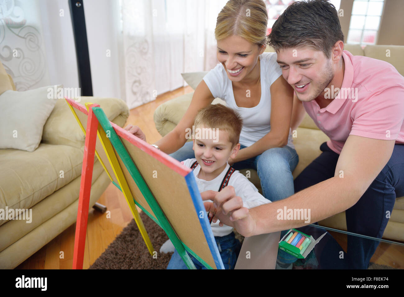 happy young family teach leassons and prepare their son for school ...