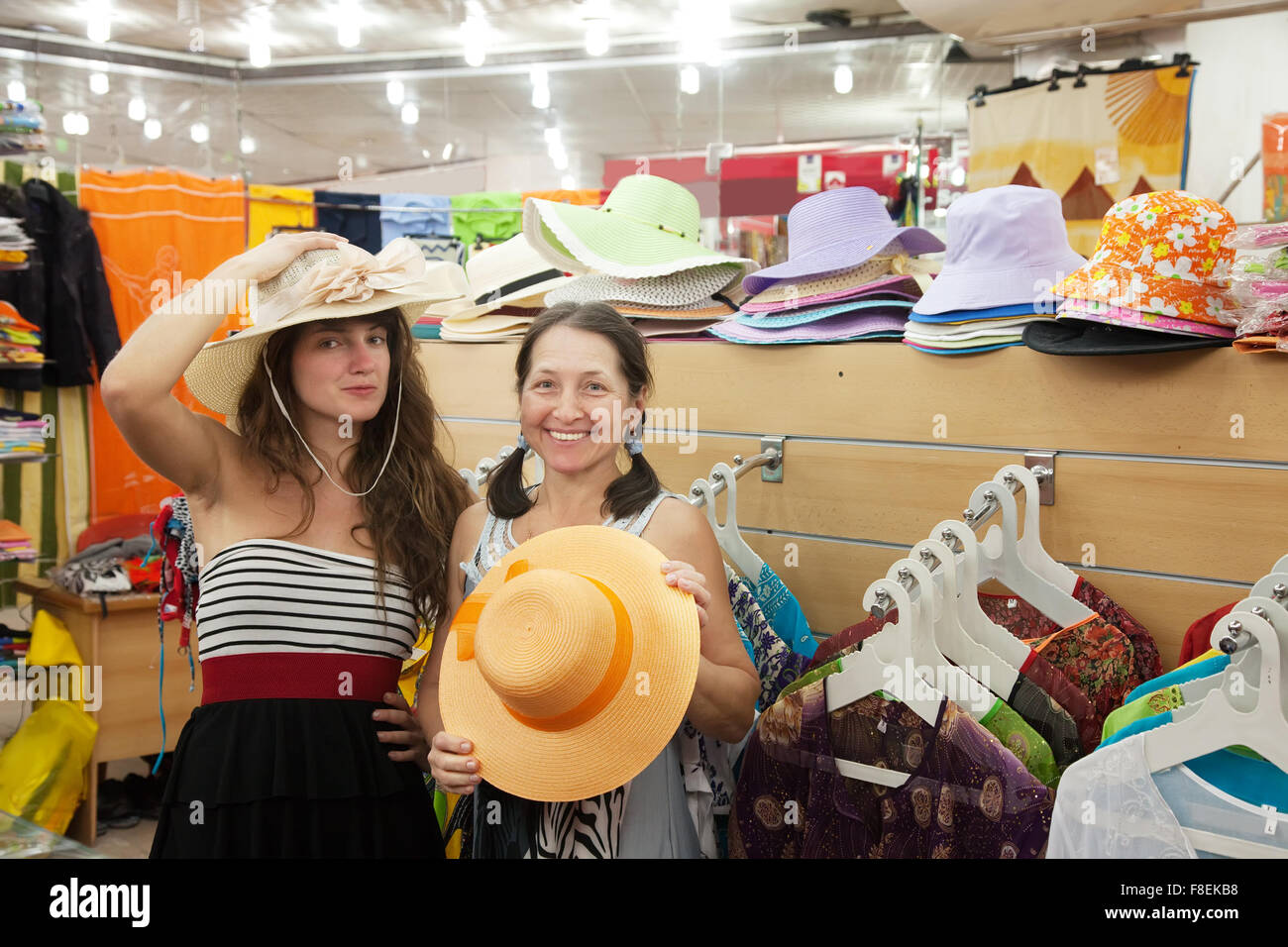 Two women chooses hat at fashionable shop Stock Photo - Alamy