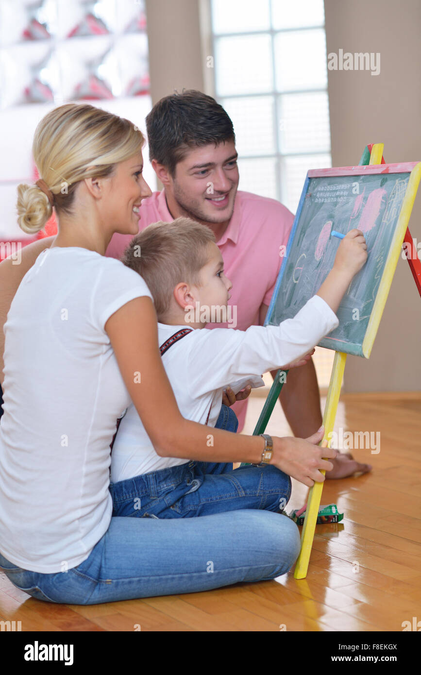 happy young family teach leassons and prepare their son for school ...