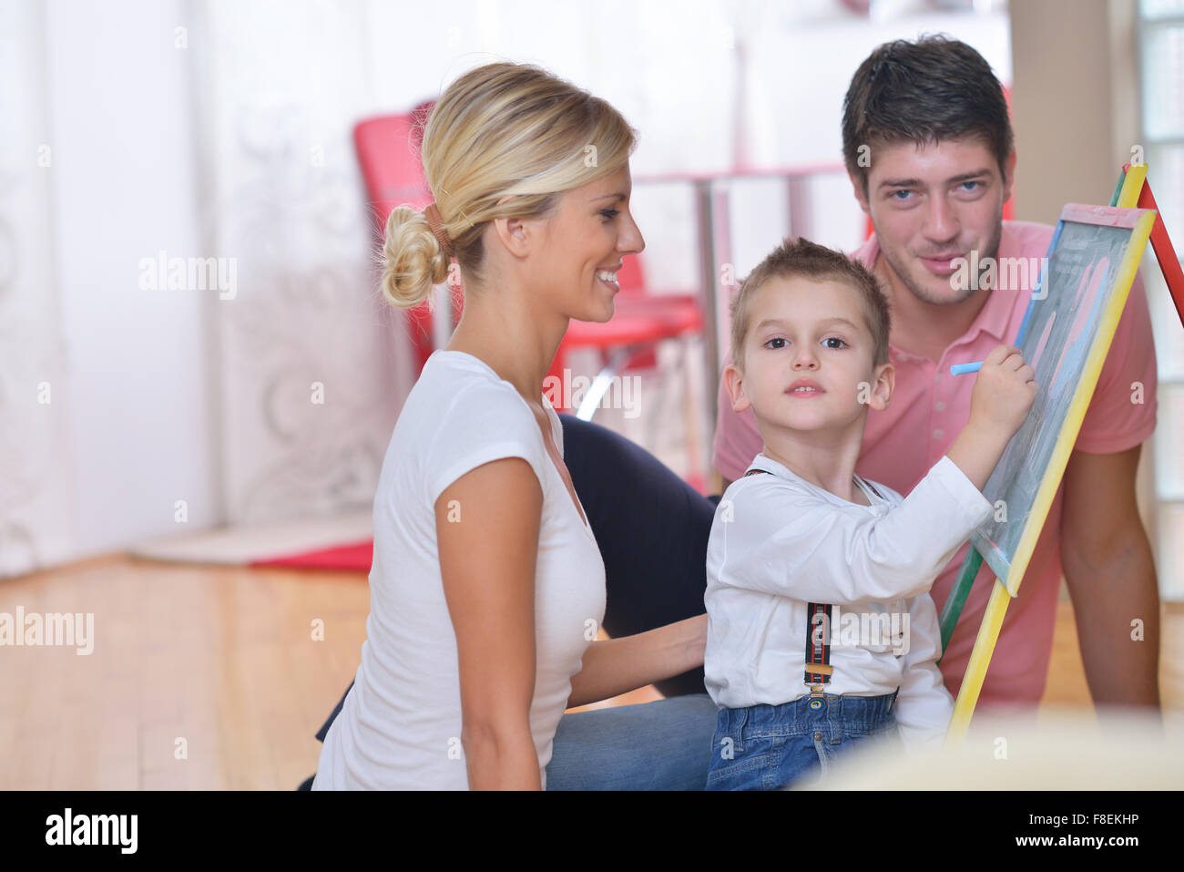 happy young family teach leassons and prepare their son for school ...
