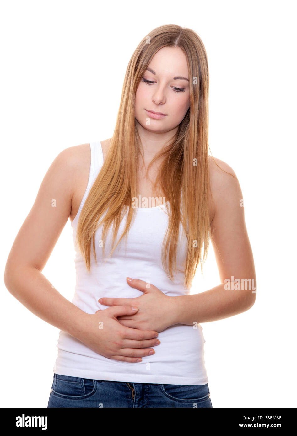 Attractive young woman suffer sfrom stomachache. All on white ...