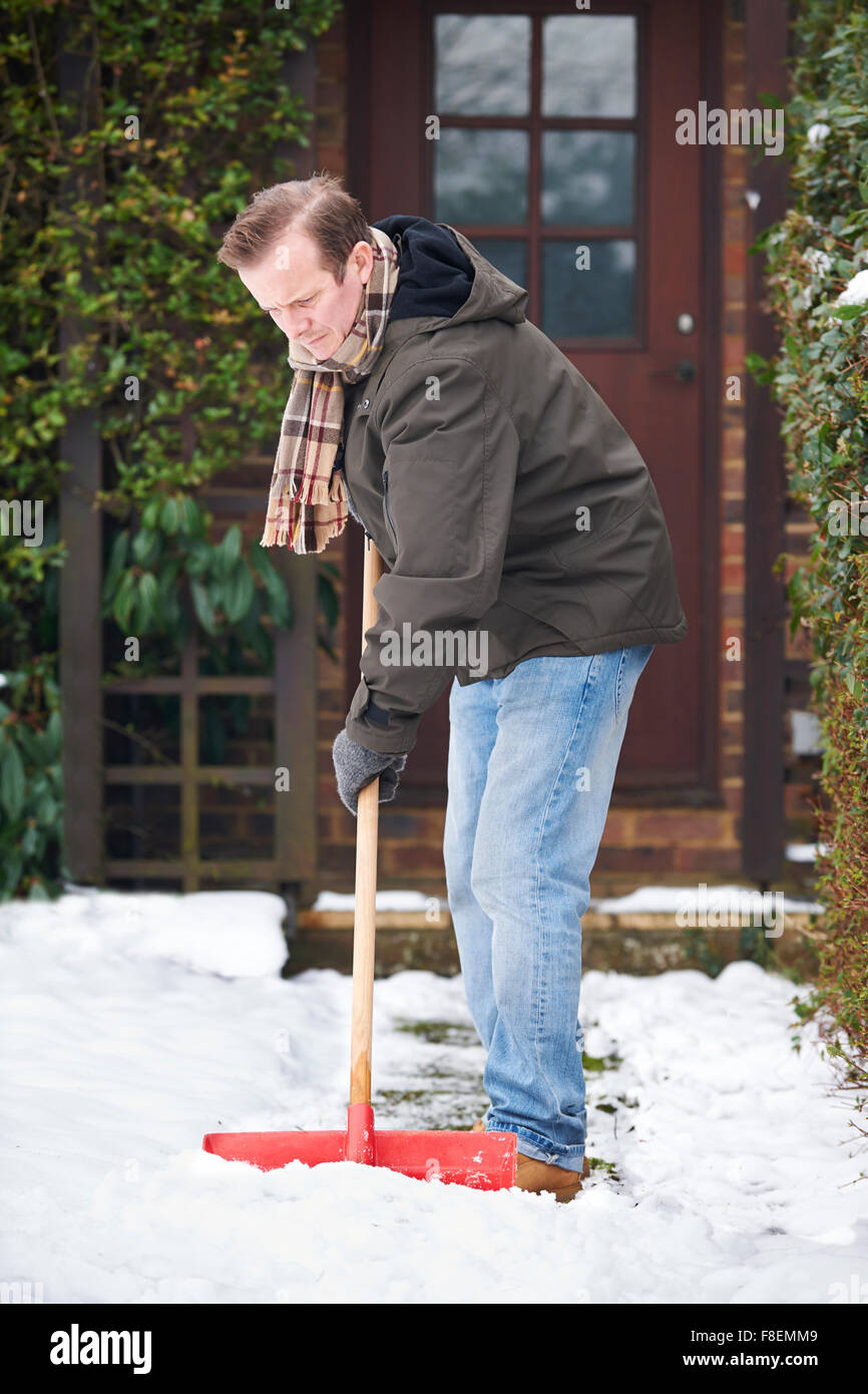 Man Clearing Snow From Path With Shovel Stock Photo - Alamy