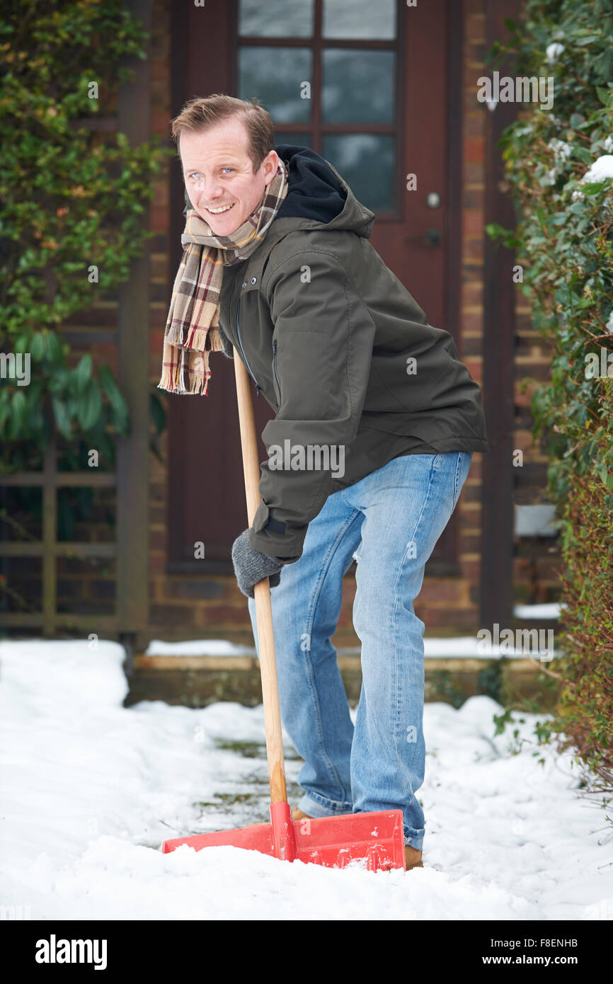 Man Clearing Snow From Path With Shovel Stock Photo - Alamy