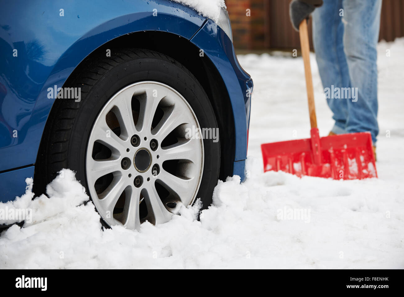 Motorist Digging Car Out Of Snow Stock Photo - Alamy