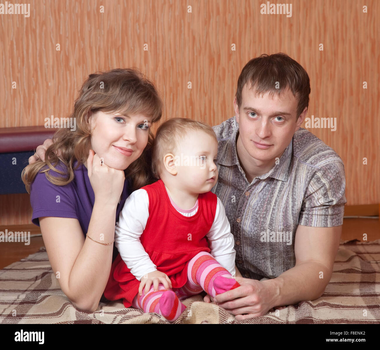 Family relaxing at home on floor Stock Photo - Alamy