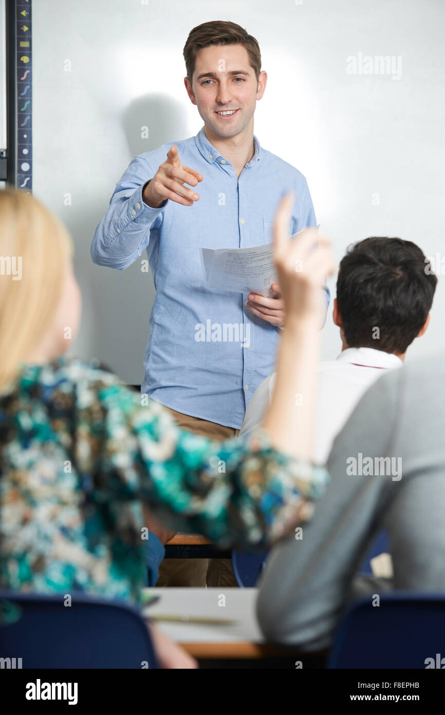Teacher Answering Pupils Question In Classroom Stock Photo - Alamy
