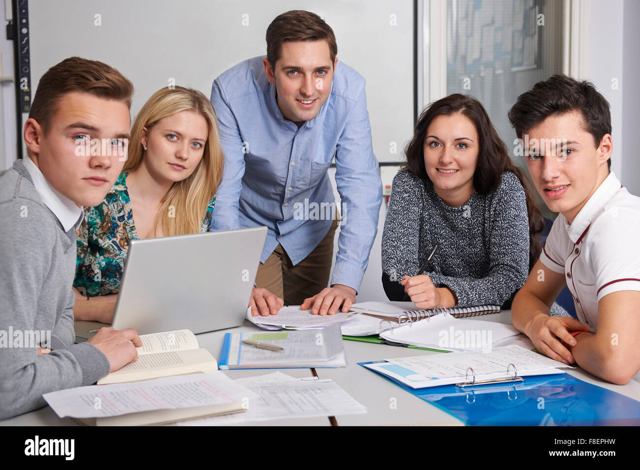 Teacher Working In Classroom With Students Stock Photo - Alamy