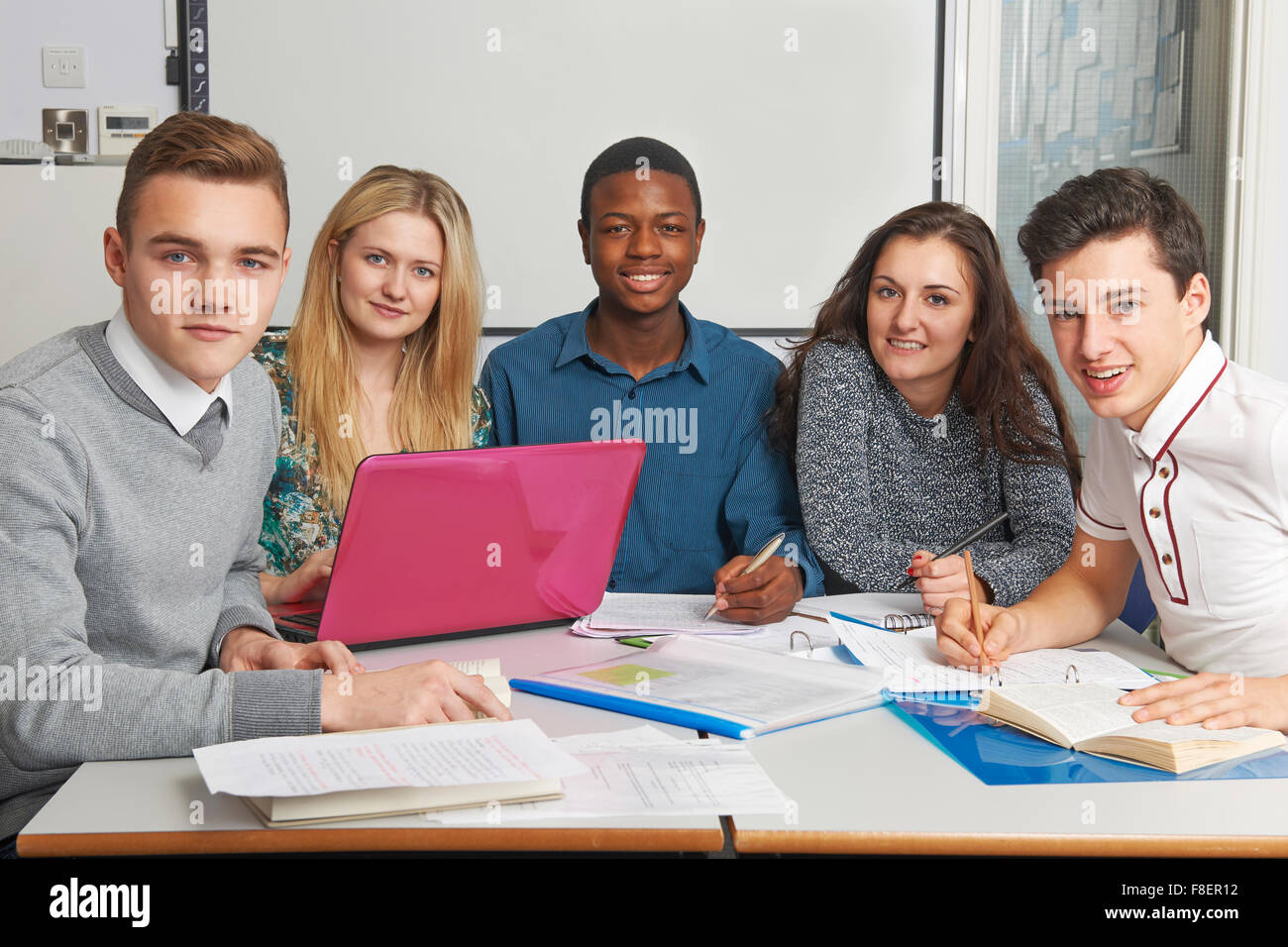Group Of Teenage Pupils Working Together In Classroom Stock Photo - Alamy