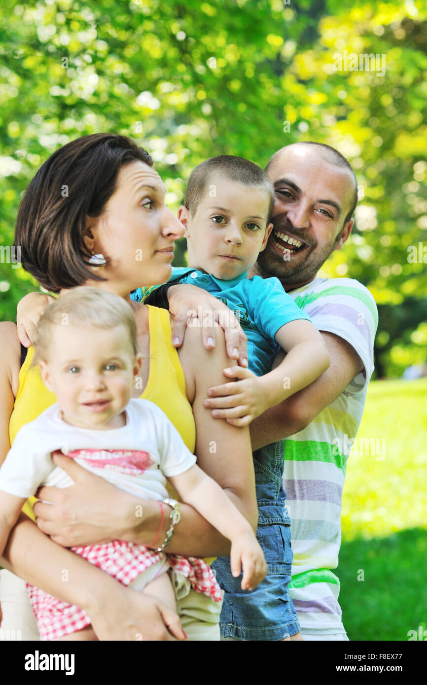 happy young couple with their children have fun at beautiful park ...