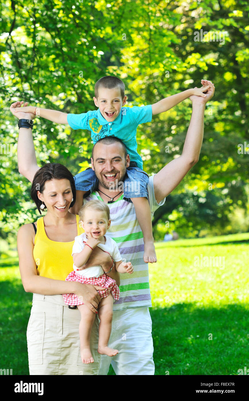 happy young couple with their children have fun at beautiful park ...