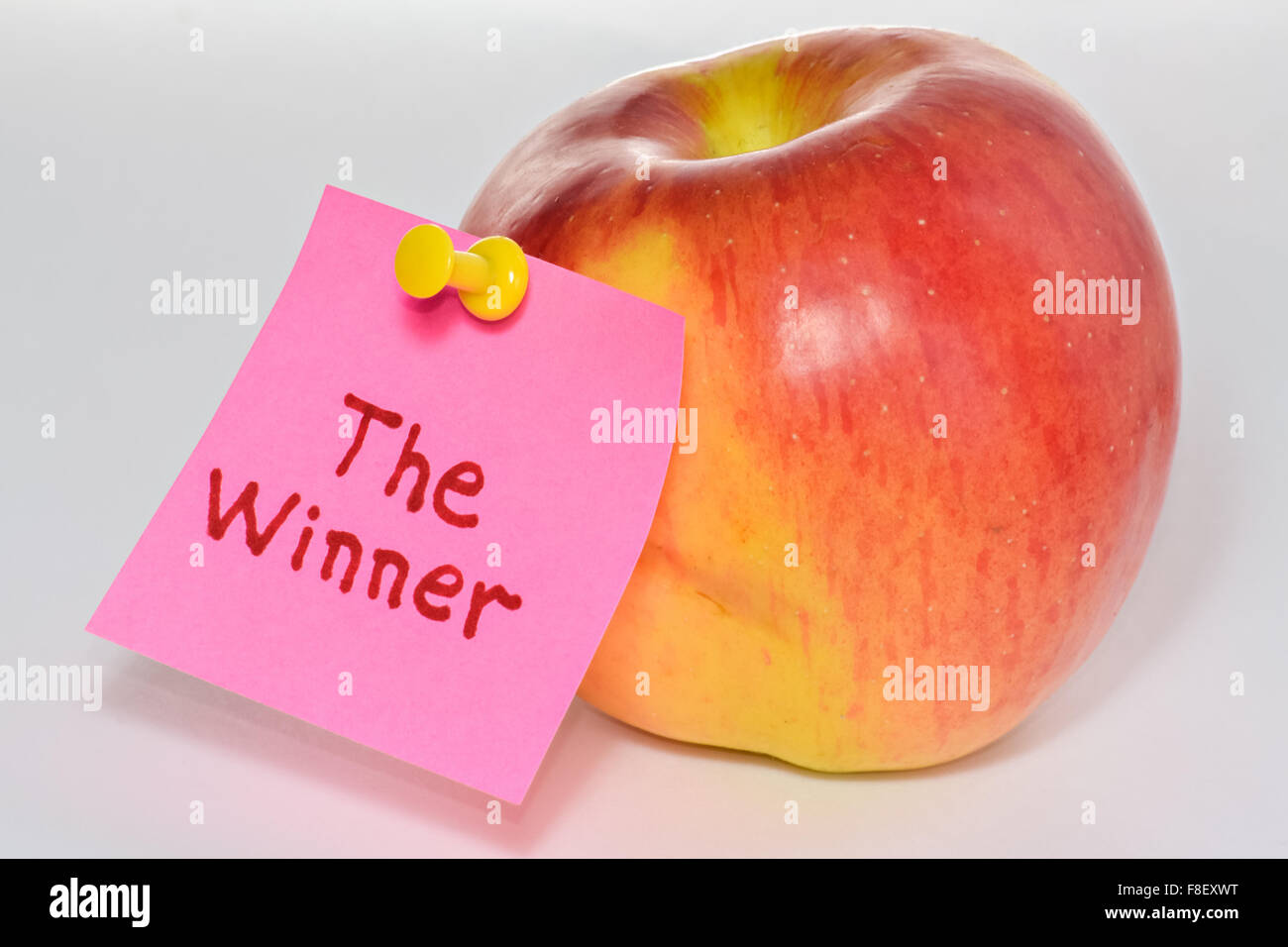 Ripe fresh apple and pink sticker pinned on it Stock Photo - Alamy