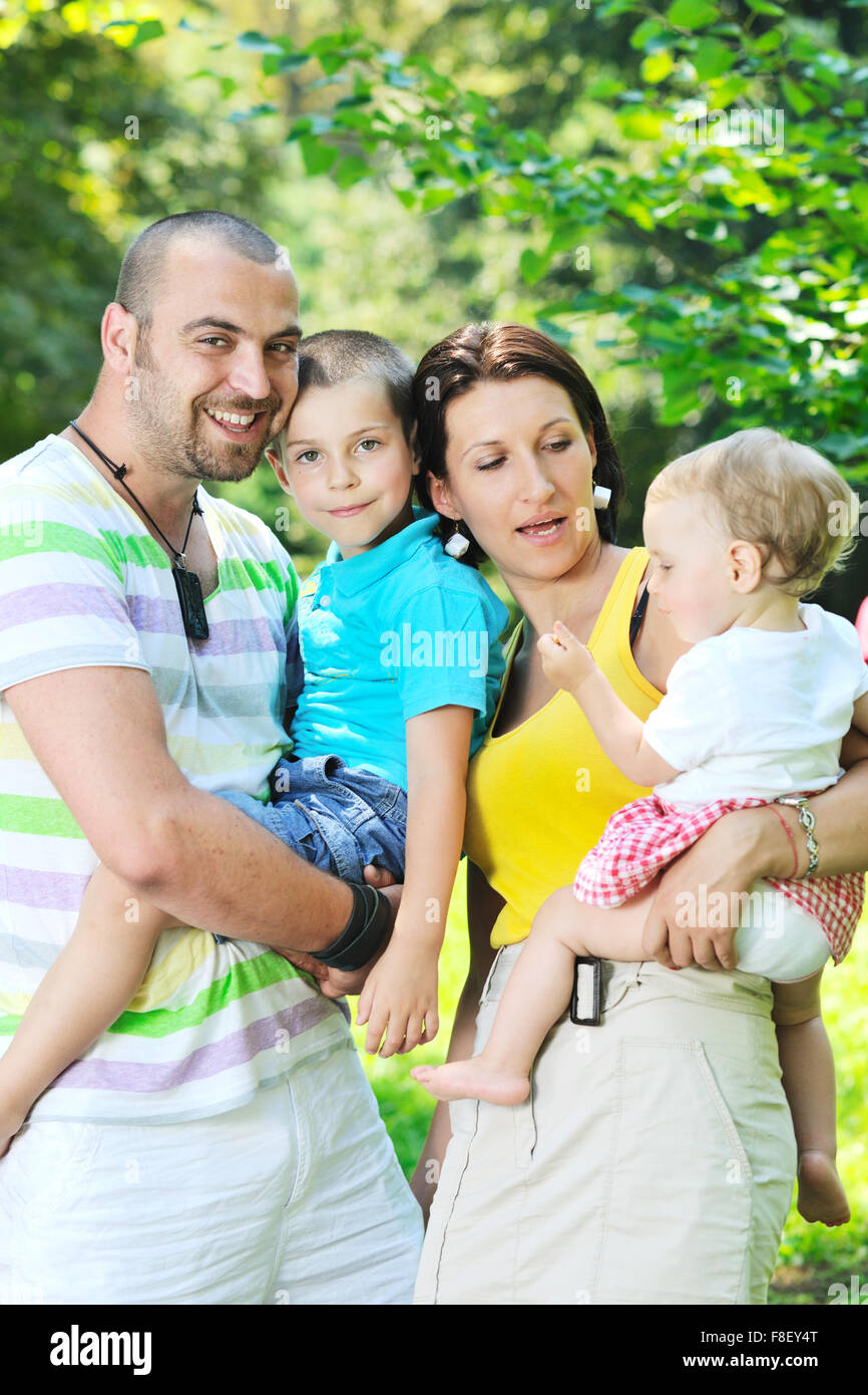 happy young couple with their children have fun at beautiful park ...