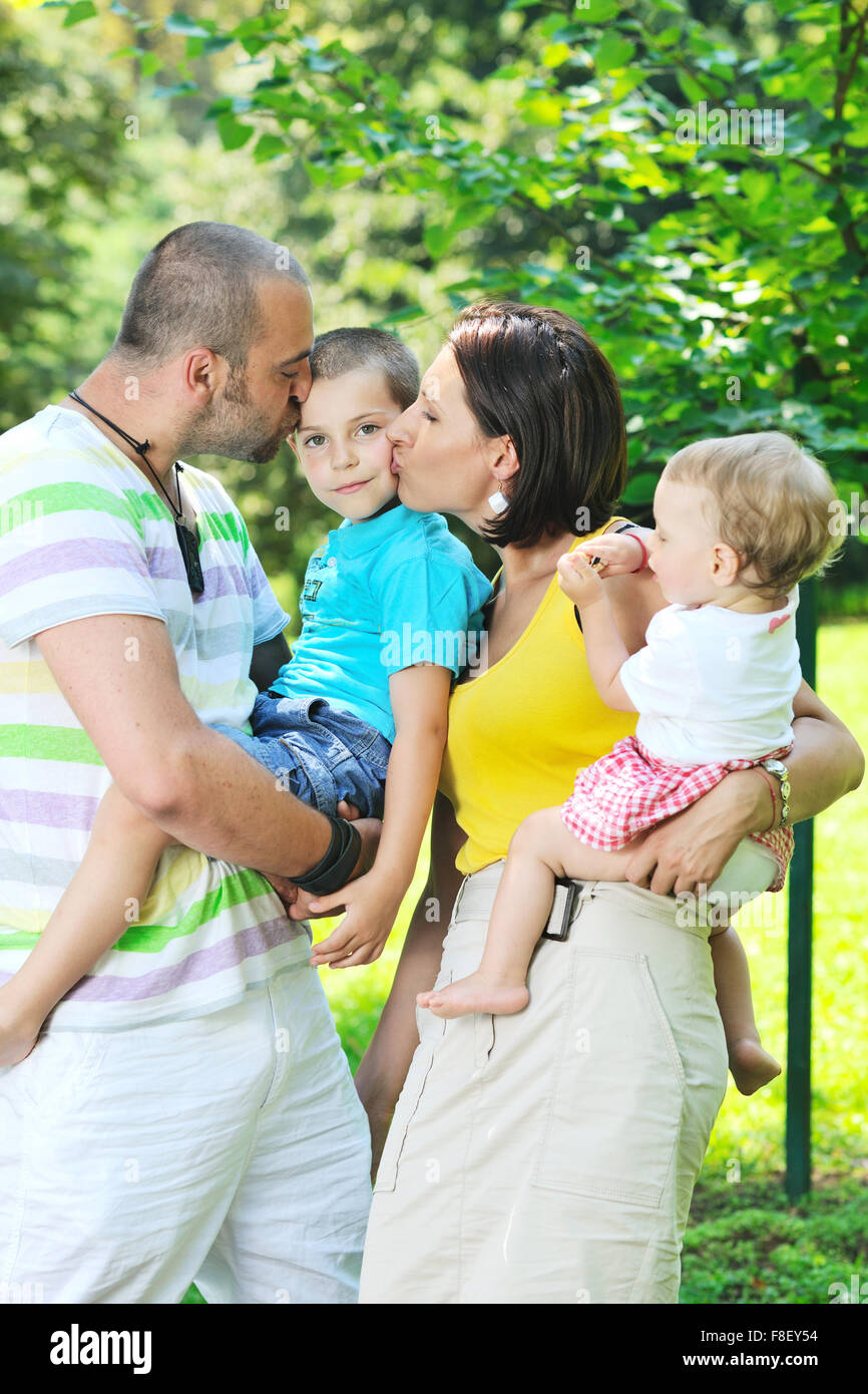 happy young couple with their children have fun at beautiful park ...