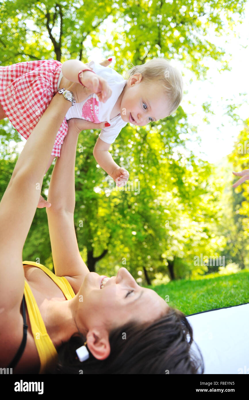 happy young woman and baby have fun while playing in beautiful bright ...
