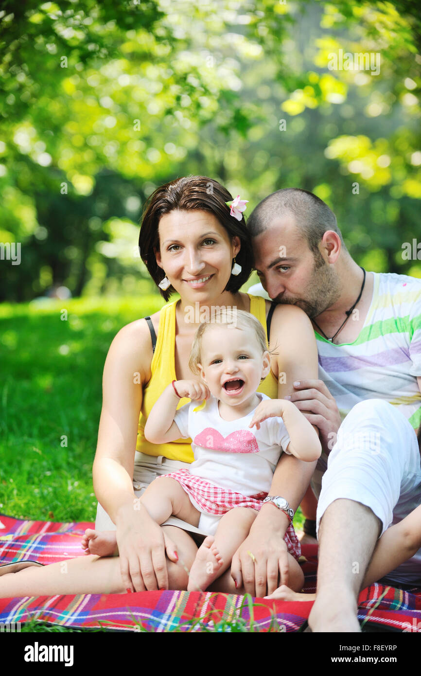happy young couple with their children have fun at beautiful park ...