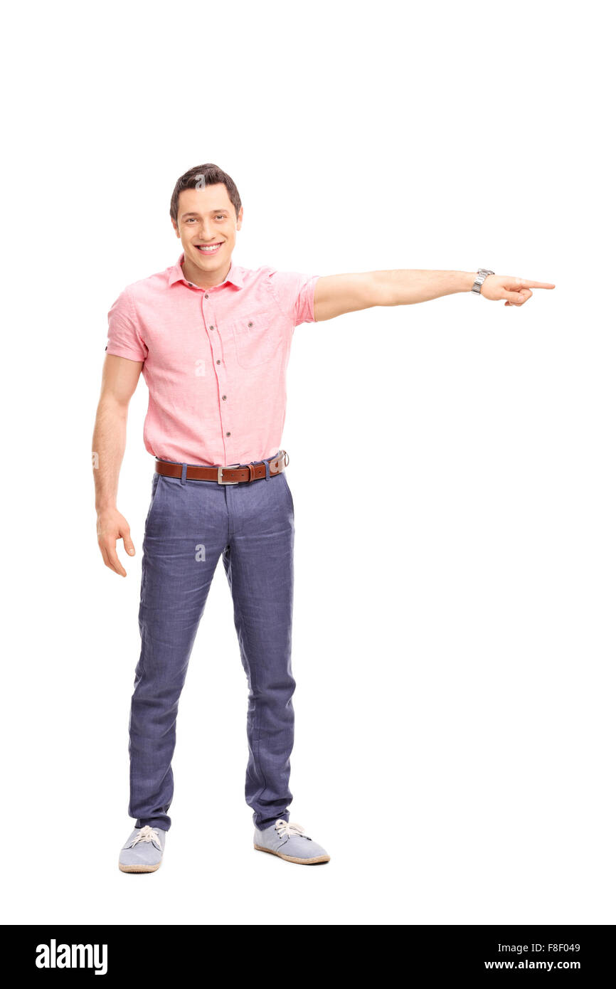 Full length portrait of a young casual man pointing to the right with ...
