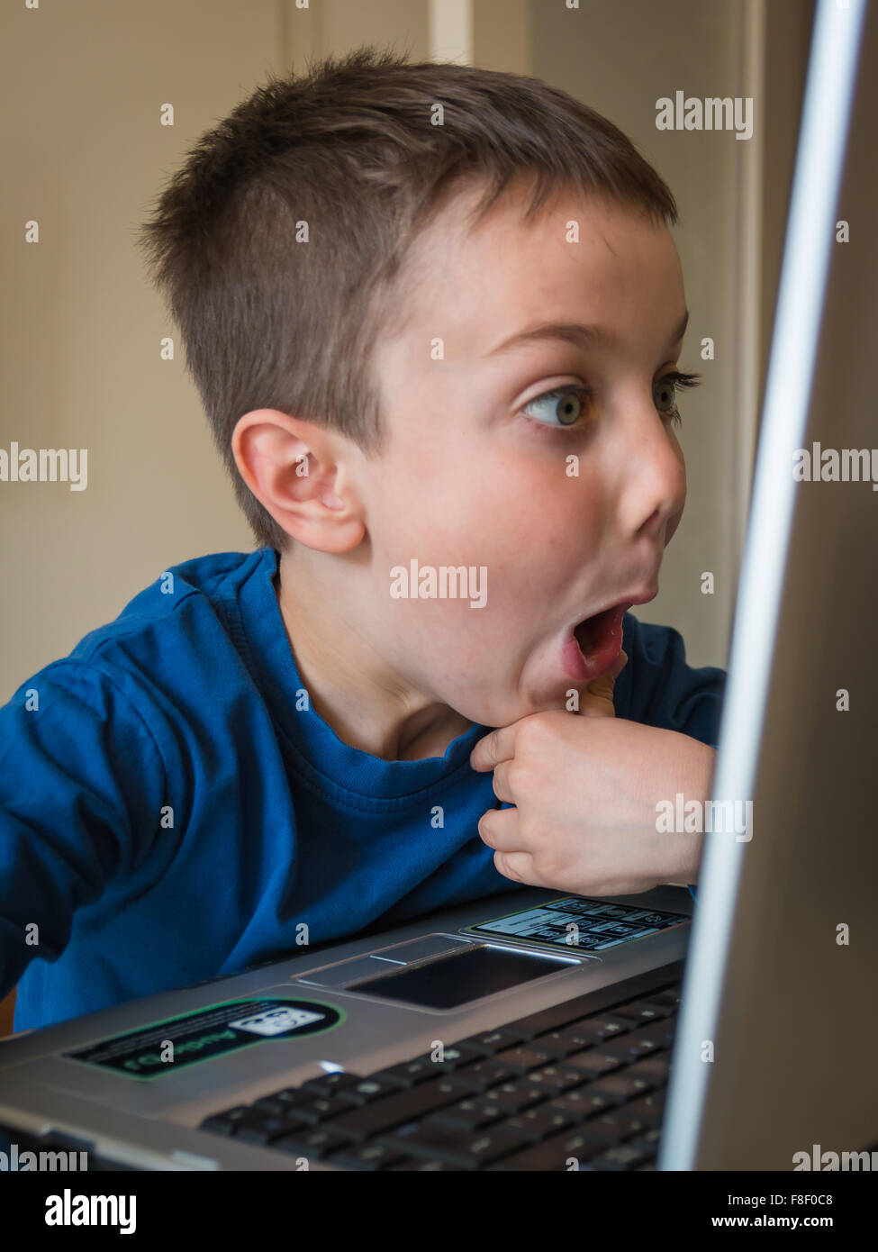 Surprised Child With Touch Screen Laptop Stock Photo - Alamy
