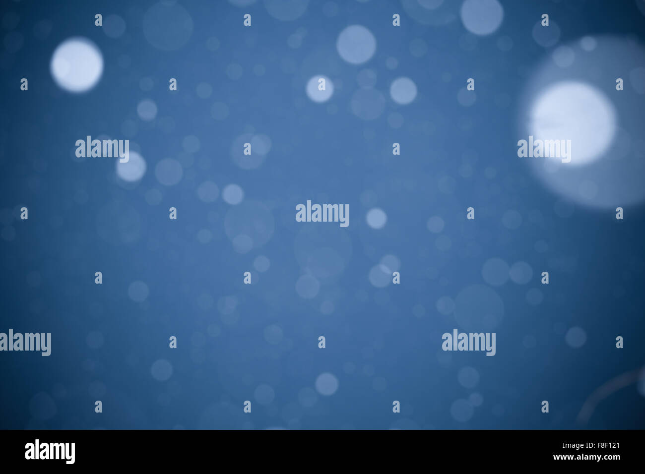 Falling snow on blue background Stock Photo - Alamy