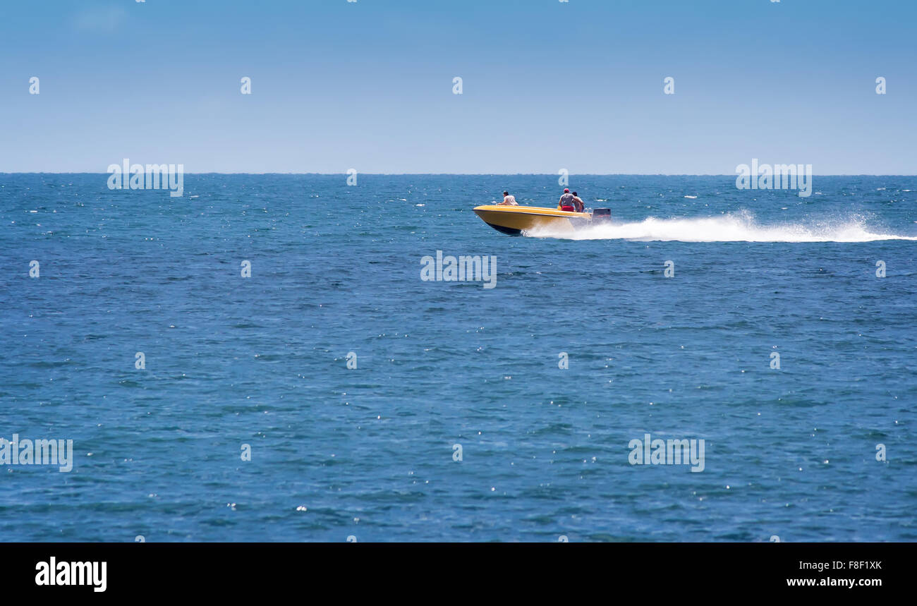 By sea fast boat with three passengers into the sea Stock Photo - Alamy