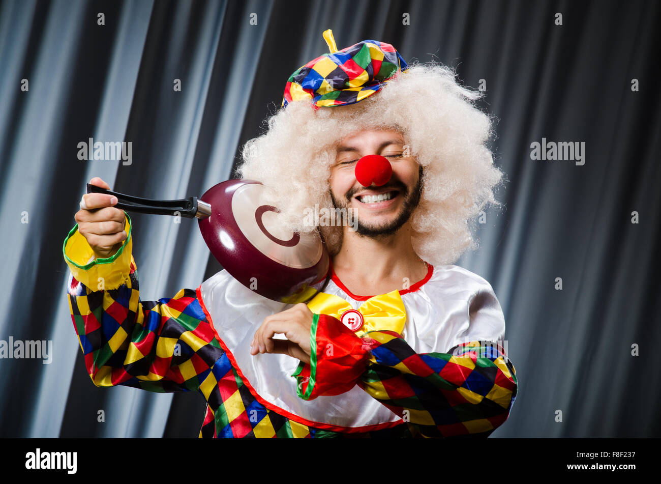 Angry clown with frying pan Stock Photo - Alamy
