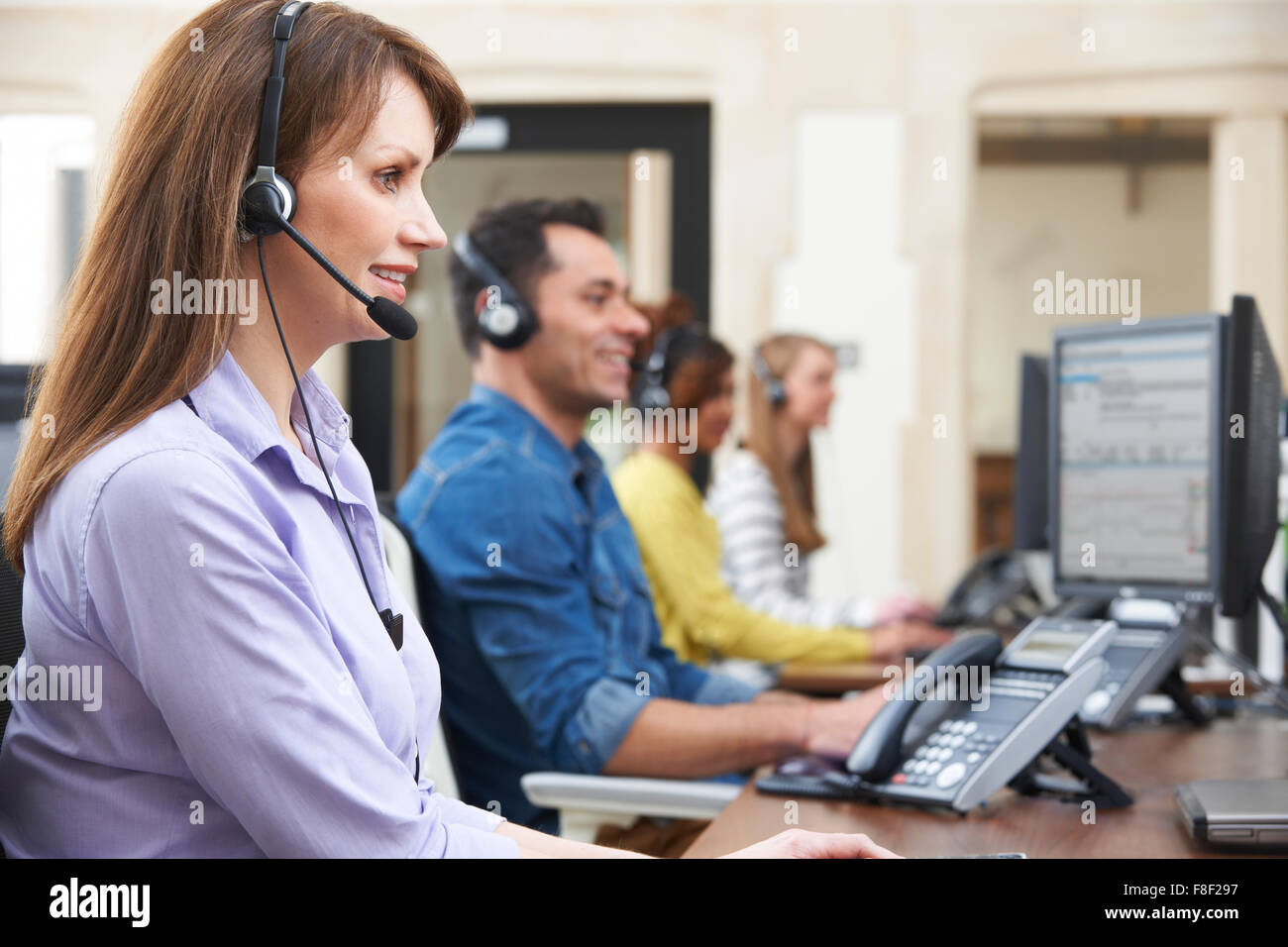 Team call centre agents talking hi-res stock photography and images - Alamy