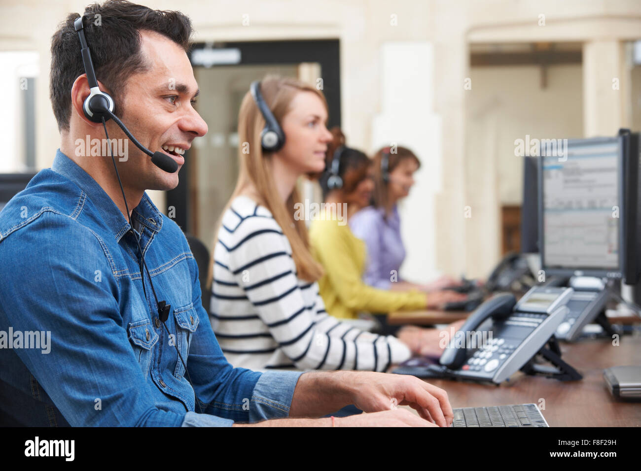 Customer Services Agents In Call Centre Stock Photo - Alamy