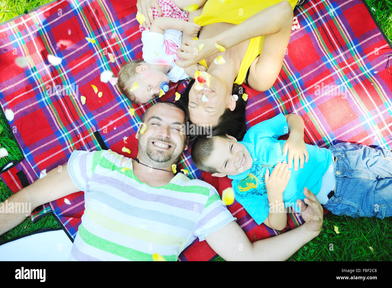 happy young couple with their children have fun at beautiful park ...