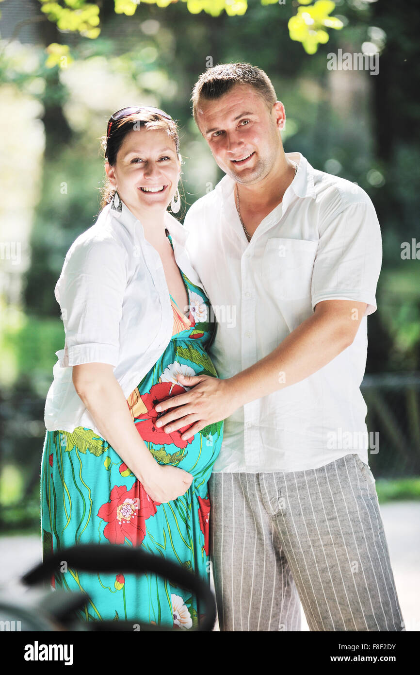 Happy pregnant couple have fun and romantic time at beautiful sunny day ...
