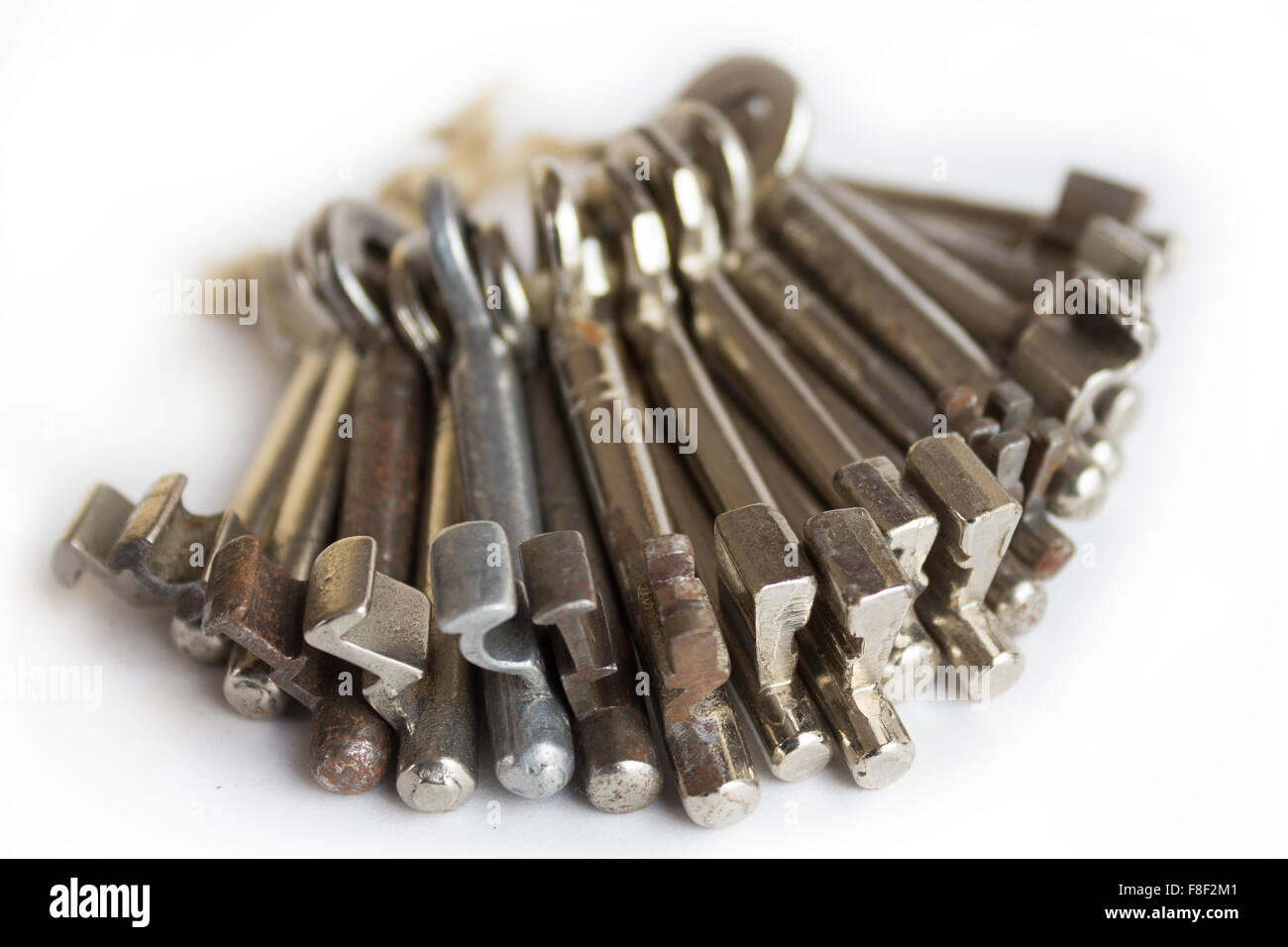 bunch of keys isolated on white background - keyring with old keys ...
