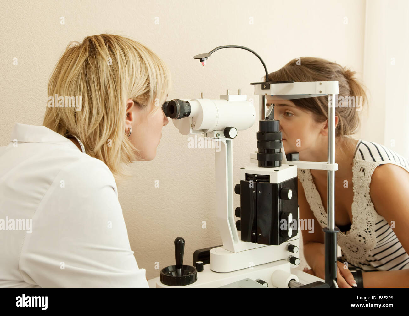 ophthalmologist and patient testing eyesight in clinic Stock Photo - Alamy