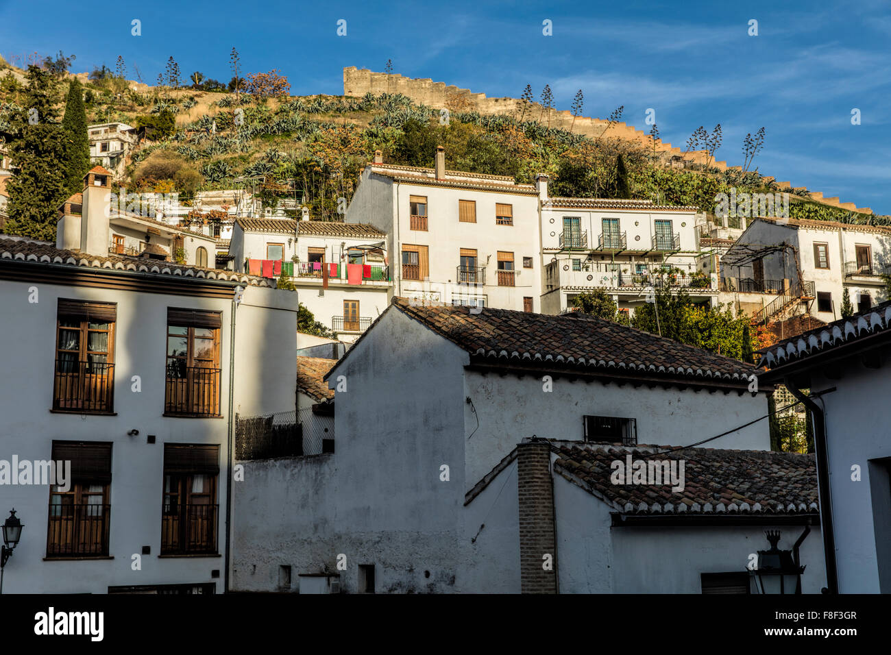 White houses in the foreground with the sun on white houses and caves ...