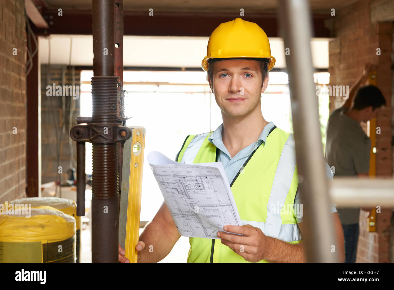 Portrait Of Builder On Site With Plans Stock Photo - Alamy