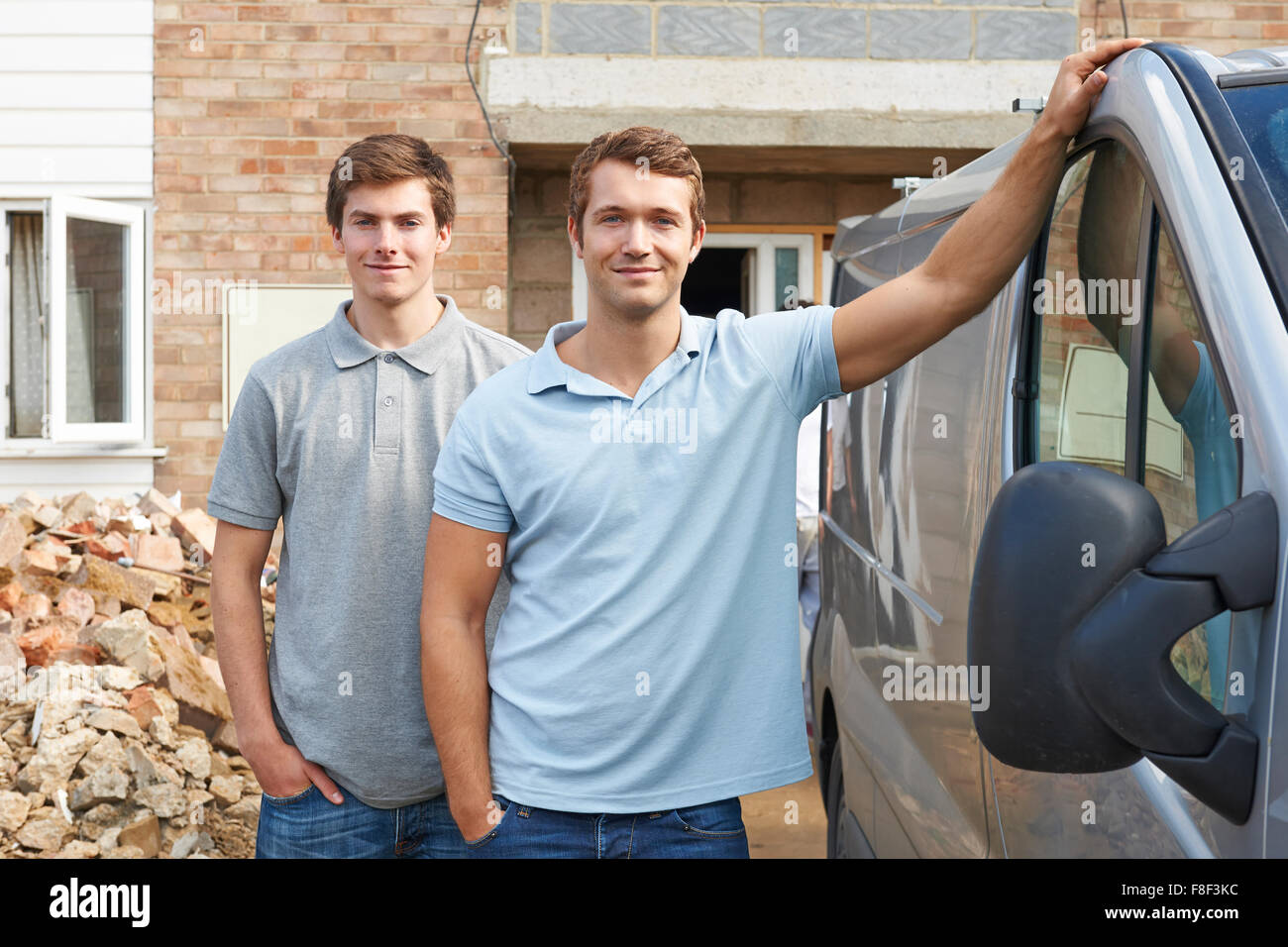 Two Builders Standing Next To Van Stock Photo - Alamy