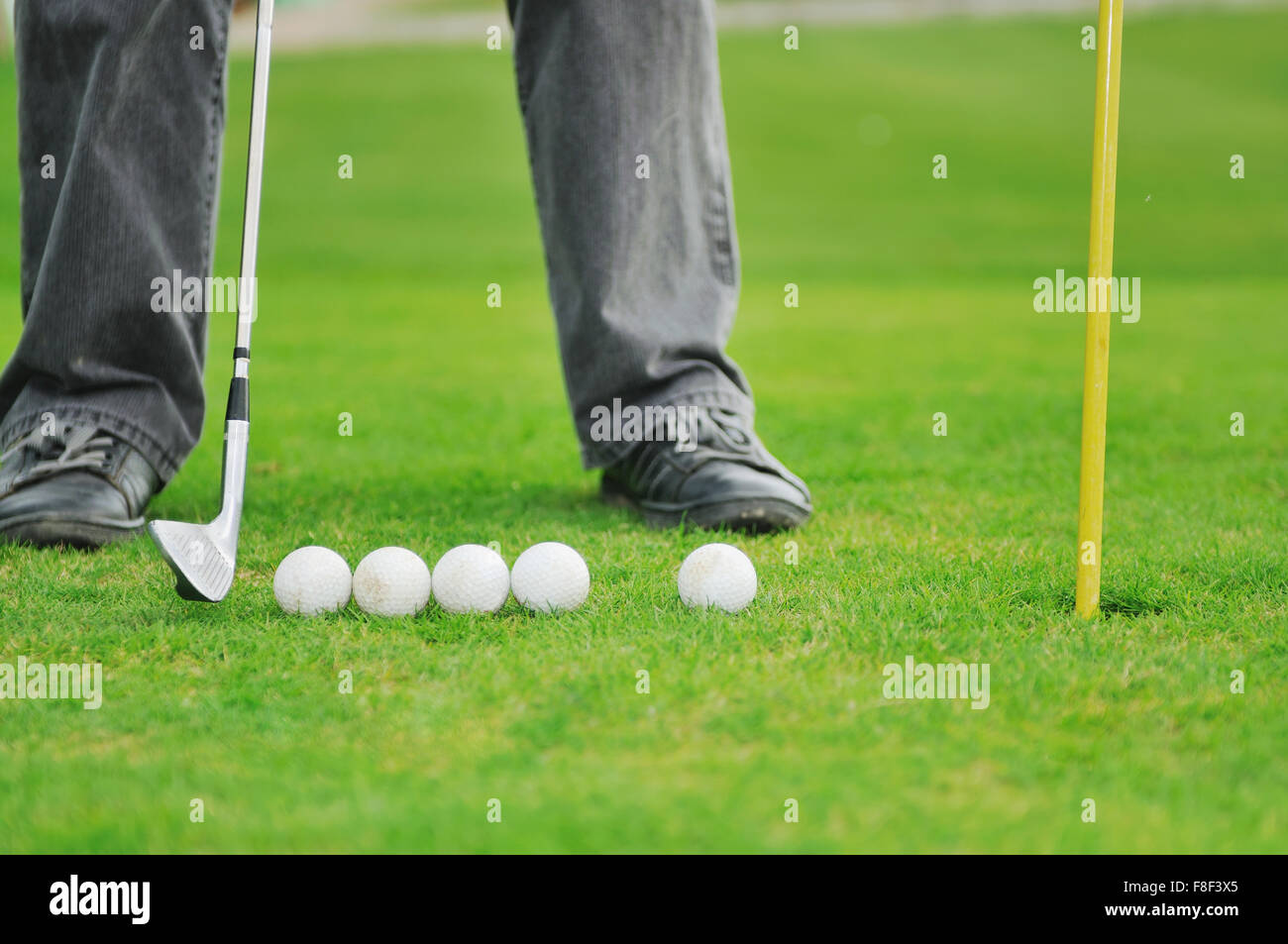 golf ball on sports golf course and hole Stock Photo - Alamy