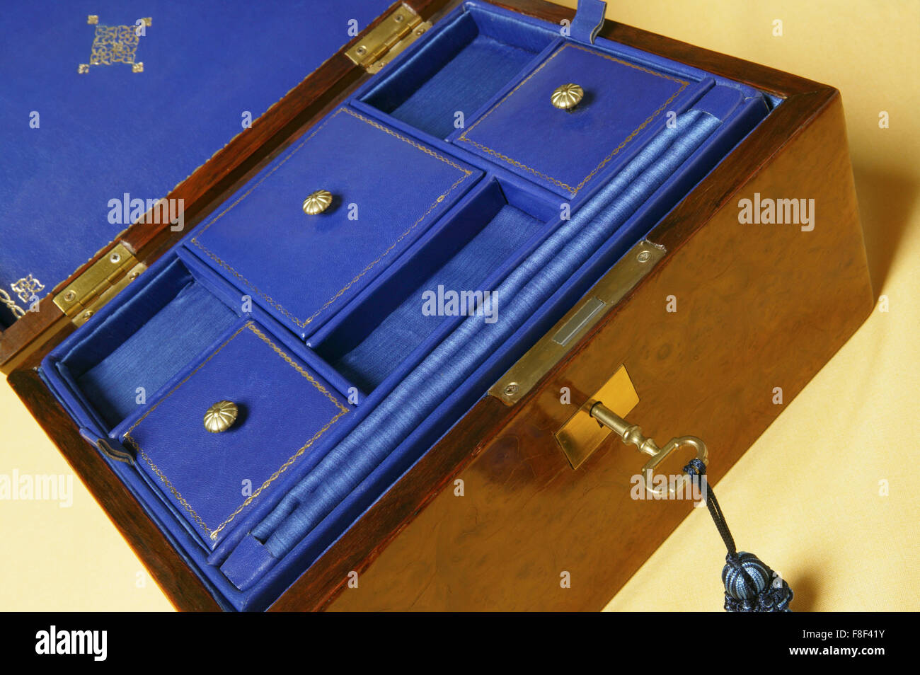 An open old jewelry box with compartments on blue velvet Stock Photo ...