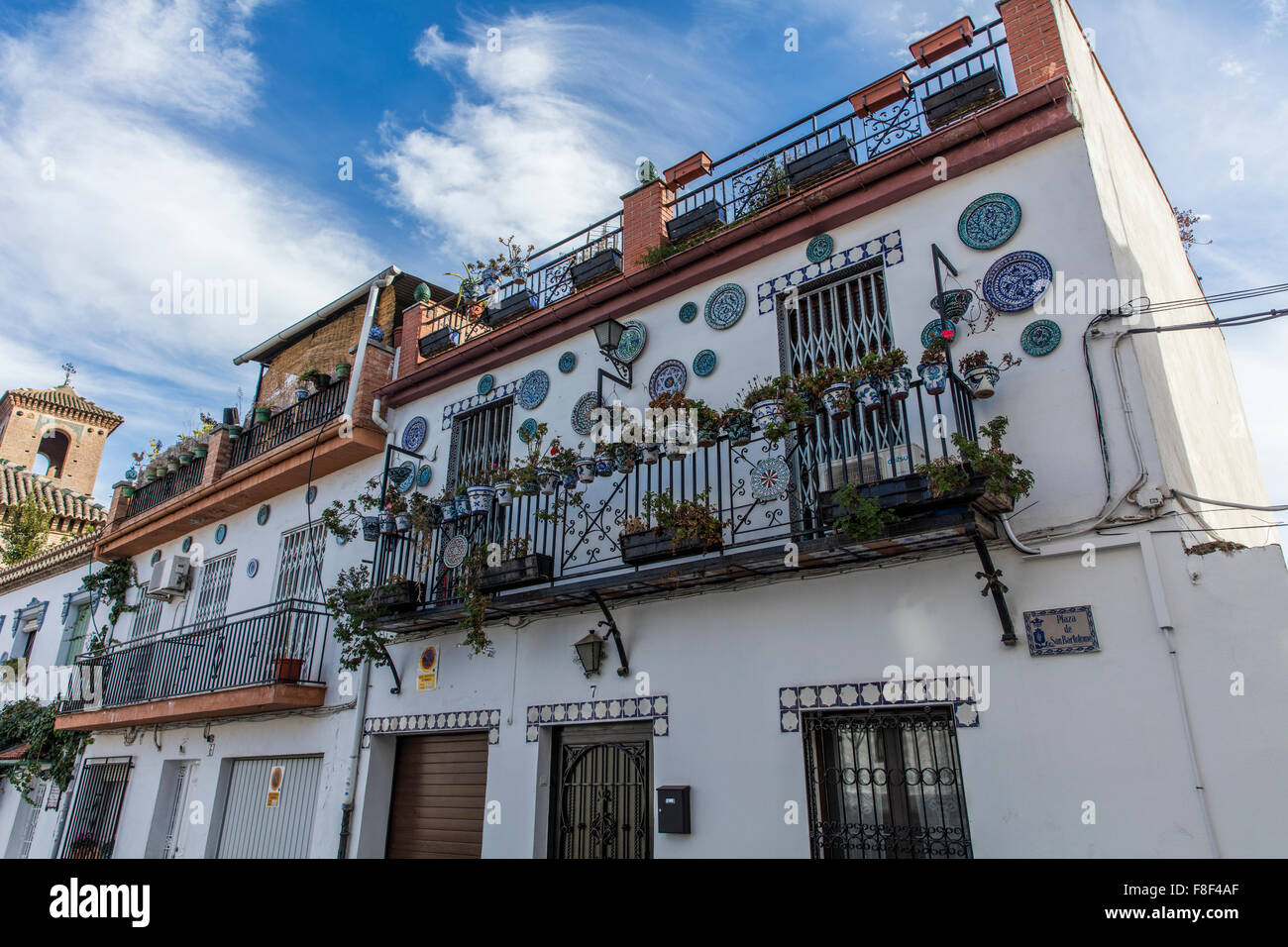 Row of white Spanish houses in Granada with balconies full of geranium ...