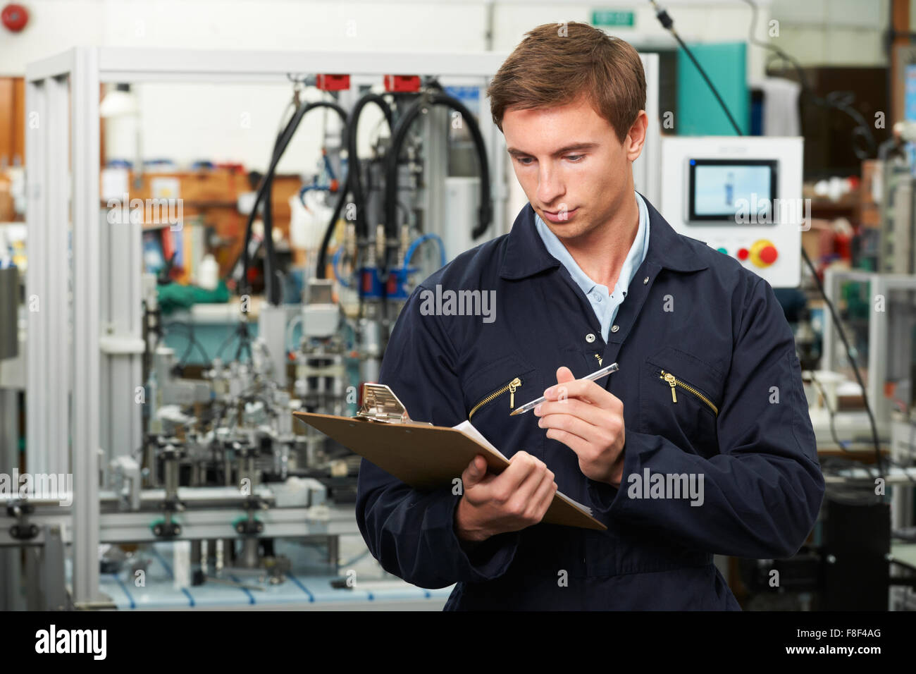 Engineer Writing On Clipboard In Factory Stock Photo - Alamy
