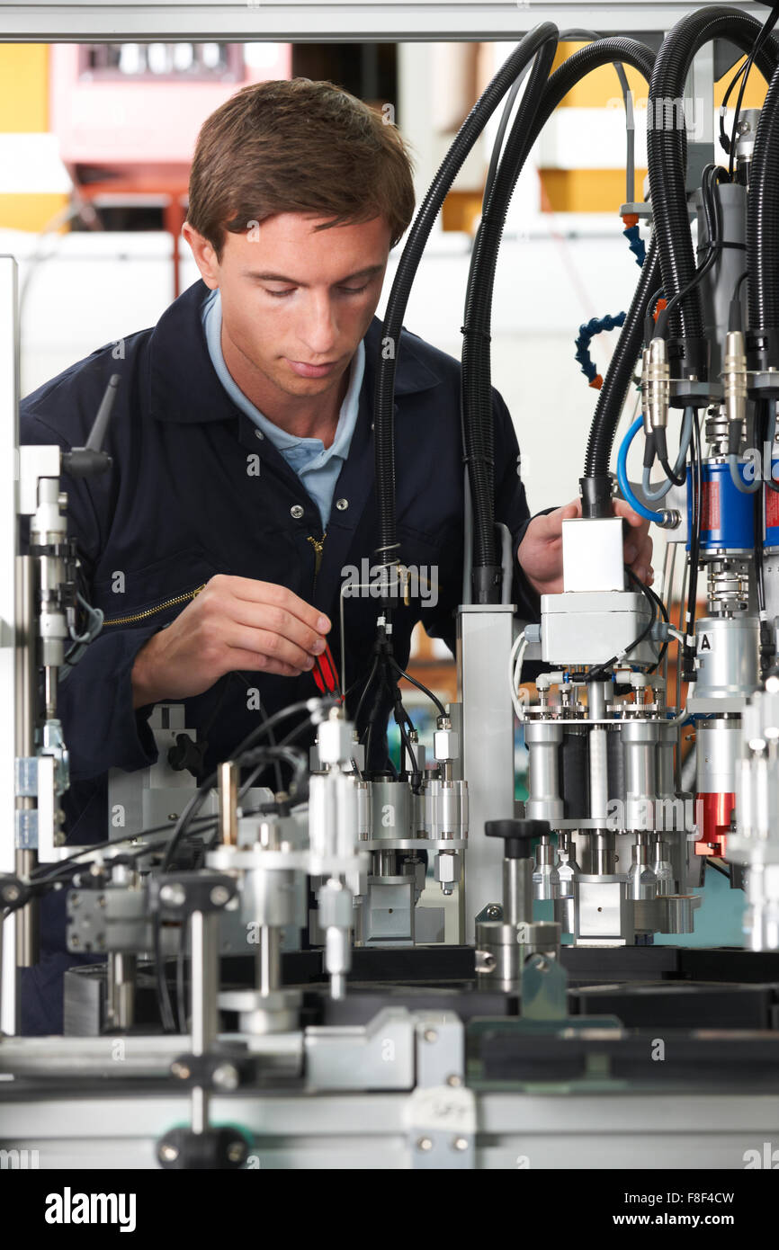 Engineer Working On Complex Equipment In Factory Stock Photo - Alamy