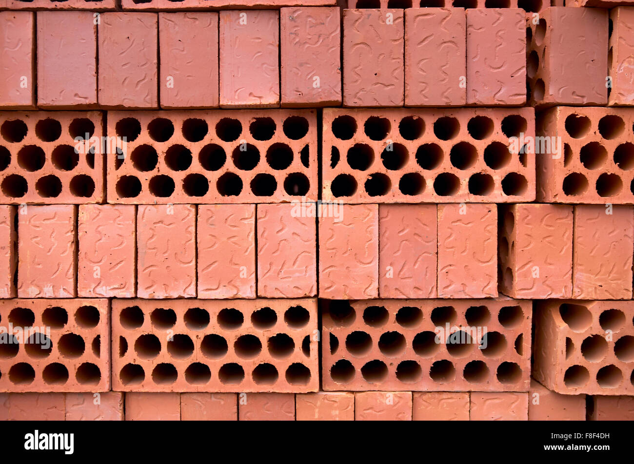 A pile of new bricks at construction site sitting on pallet Stock Photo ...