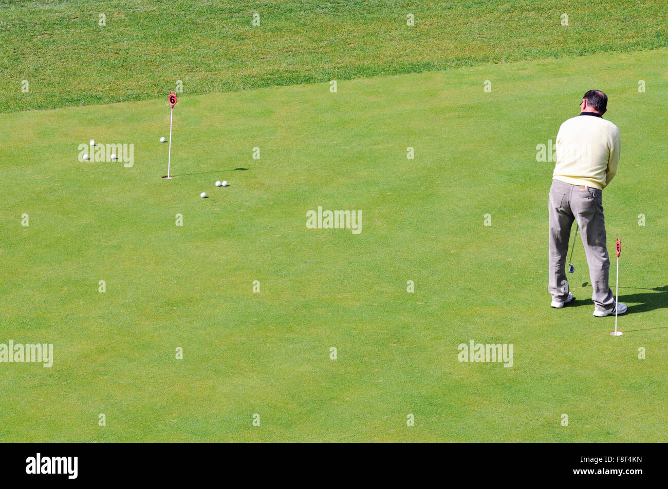 golf ball on sports golf course and hole Stock Photo - Alamy