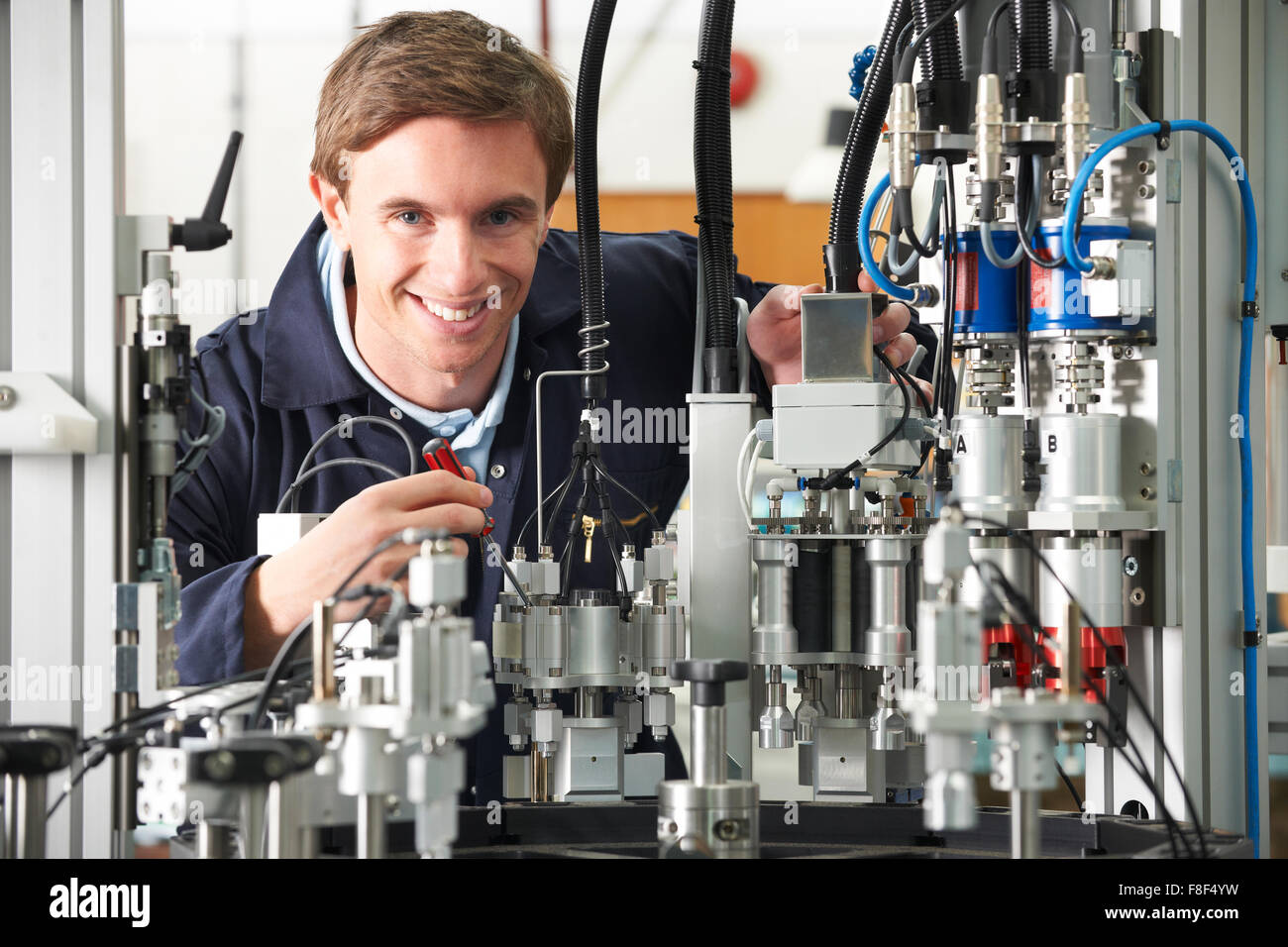 Engineer Working On Complex Equipment In Factory Stock Photo - Alamy