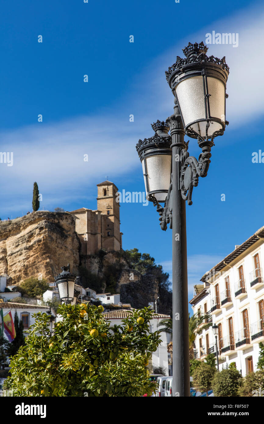 Traditional Spanish street lamps with the church on the top of the ...