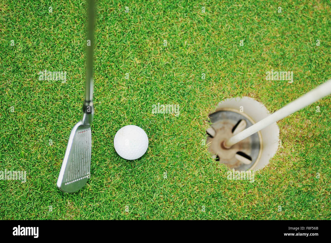 golf ball on sports golf course and hole Stock Photo - Alamy