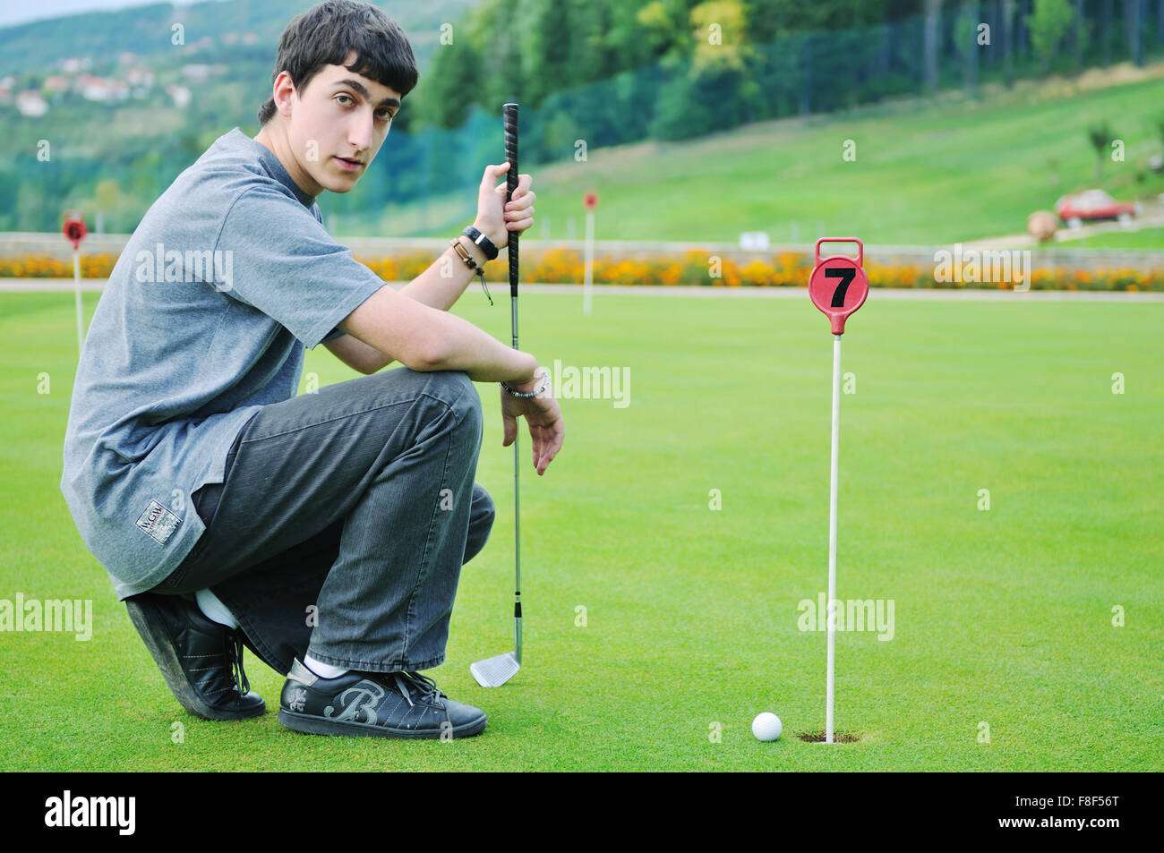golf ball on sports golf course and hole Stock Photo - Alamy