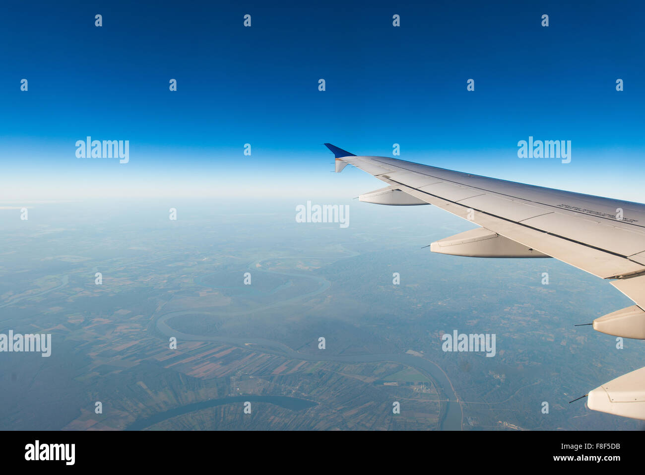 Airplane wing out of window Stock Photo - Alamy